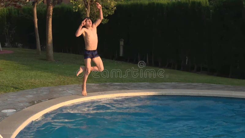 Happy Kids Playing Jumping in Blue Water in the Pool in Summer Stock ...