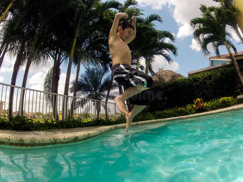 Kid jumping in pool stock image. Image of swimming, pool - 24665643