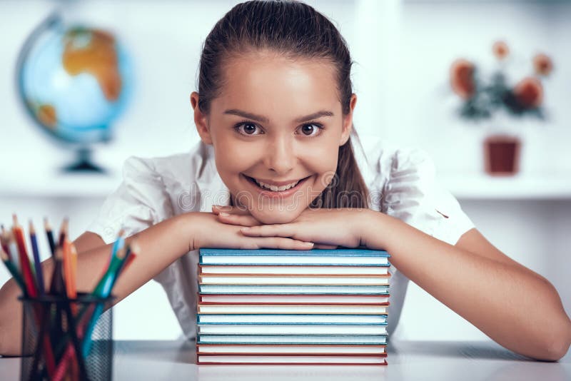 Kid is Leaned To Books Stack at Primary School. Stock Image - Image of ... Kid is Leaned To Books Stack at Primary School. Stock Image - Image of ...