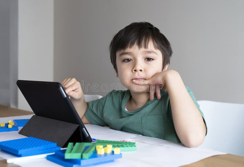 Kid Learning Math Online on Tablet and Using Plastic Block Counting ...