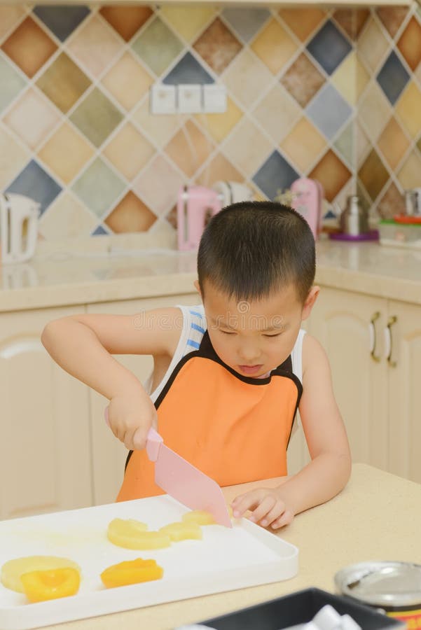 Kid learning to cook stock photo. Image of cook, dice - 77255214