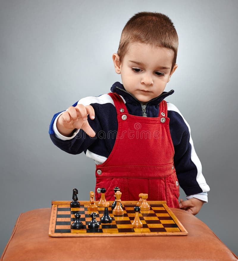 Kid learning to play chess stock image. Image of play - 41477409