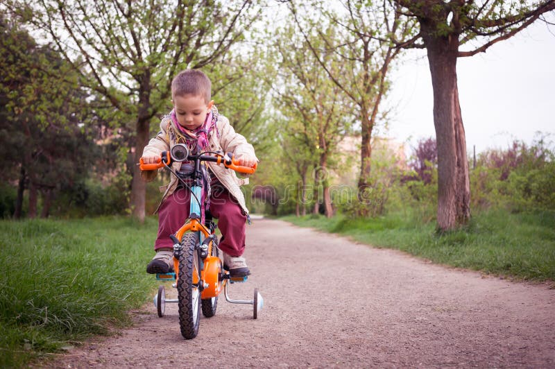 Kid Learning To Ride the Bicycle in the Park Stock Photo - Image of ...