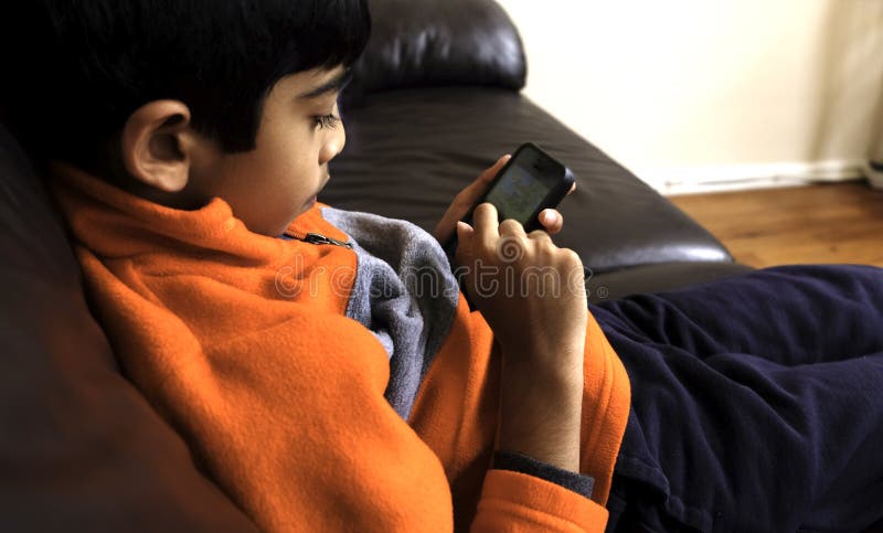 Kid is Looking at His Smart Phone Stock Photo - Image of shirt, human ...