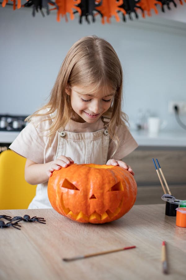 Kid Looking Inside of Carved Pumpkin while Preparing Halloween Decor ...