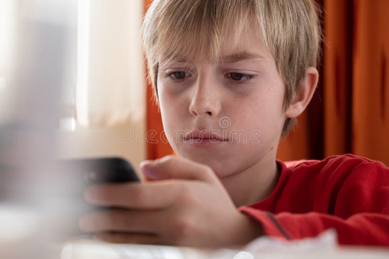 Kid Looking at Smartphone during Breakfast. Stock Image - Image of ...