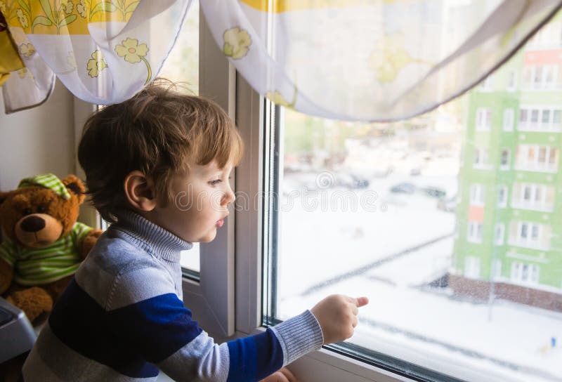 Kid looks out the window stock photo. Image of glass - 85639664