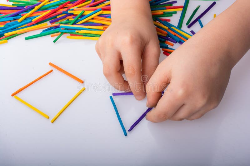Kid Making Geometric Shapes with Colorful Sticks on White Background ...