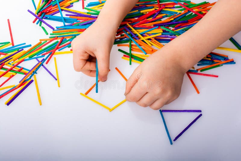 Kid Making Geometric Shapes with Colorful Sticks on White Background ...