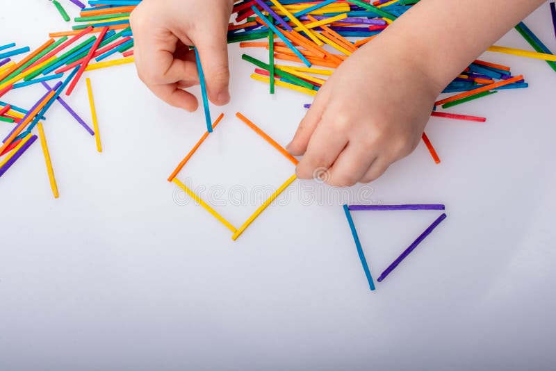 Kid Making Geometric Shapes with Colorful Sticks on White Background ...