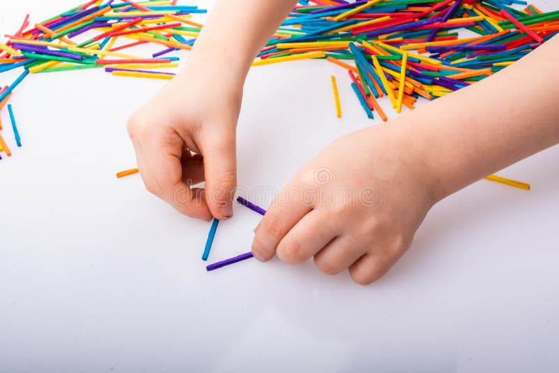 Kid Making Geometric Shapes with Colorful Sticks on White Background ...
