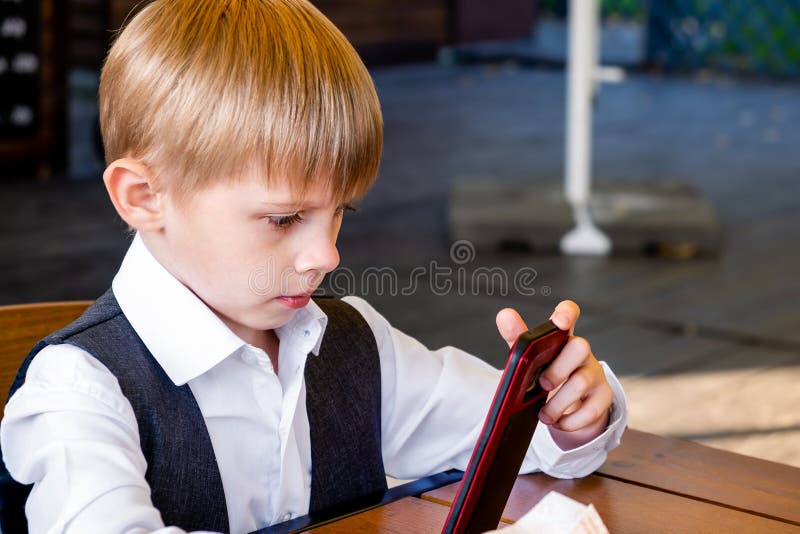 Kid with a Phone stock photo. Image of looking, play - 221420026