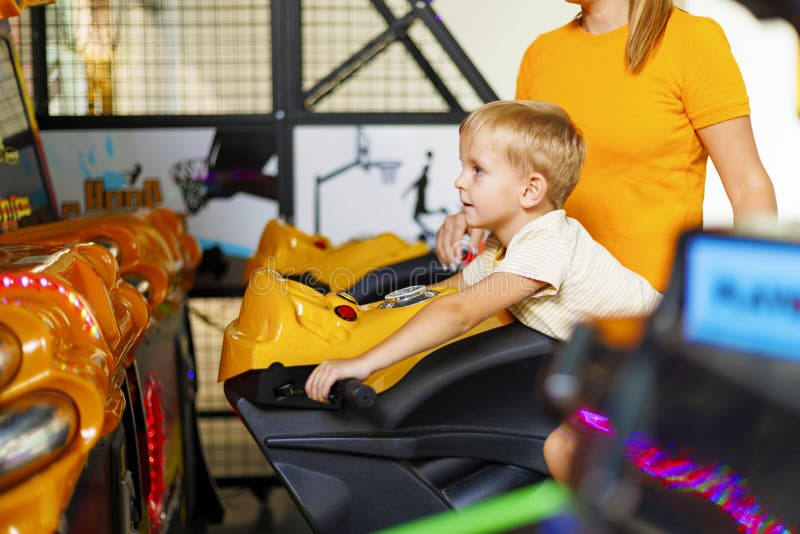 Kid Playing Arcade Simulator Machine at an Amusement Park. Stock Image ...
