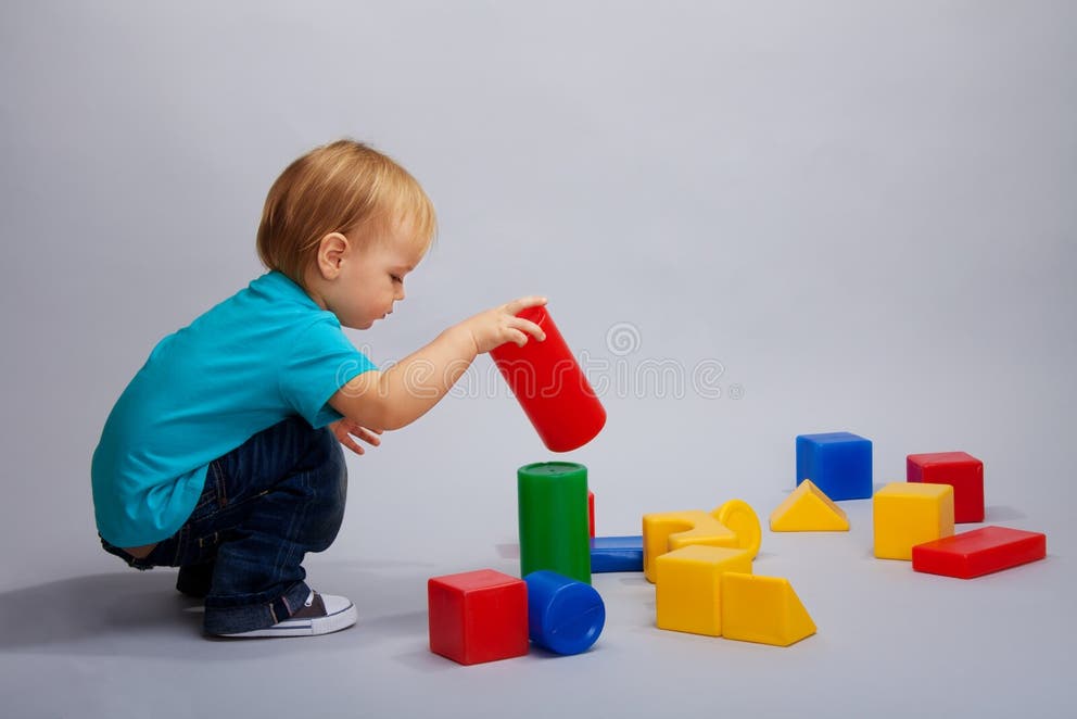 Kid playing with blocks stock image. Image of cube, library - 18835689