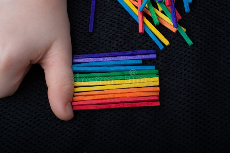 Kid Playing with Coloured Wooden Sticks for Creativity Stock Photo ...