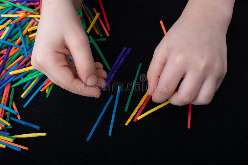 Kid Playing with Coloured Wooden Sticks for Creativity Stock Photo ...