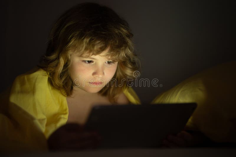 Kid Playing on a Digital Tablet. Kid Using Tablet for Gaming and Online ...