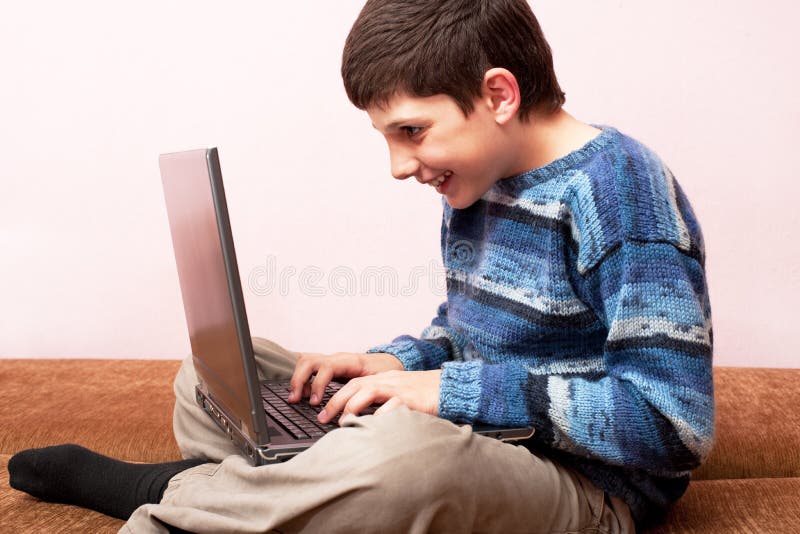 A Kid is Playing on the Laptop Stock Image - Image of keyboard, sofa ...
