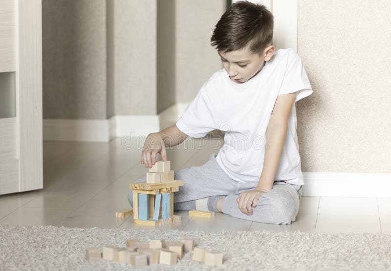 Kid is Playing with Wooden Blocks, Enjoying Stock Photo - Image of ...