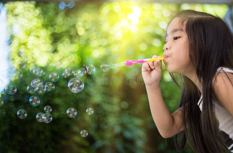 Kid PLAYLING BLowing Bubbles Together at the Field Stock Photo - Image ...