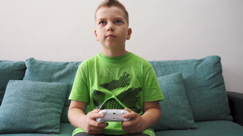 Kid Plays Console. Baby Boy Presses Joystick. Domestic Life and Leisure ...