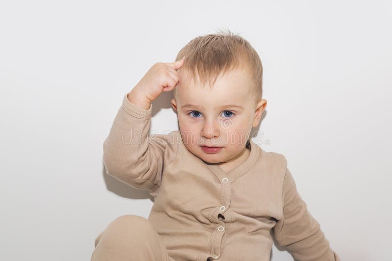 Kid Points a Finger at His Head Stock Photo - Image of looking, clever ...
