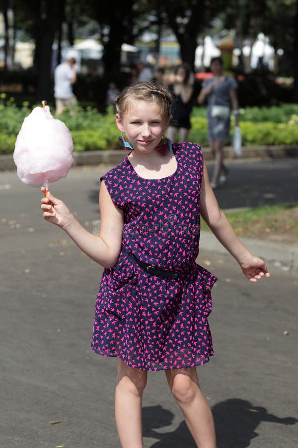 Kid Poses with Cotton Candy Stock Photo - Image of person, cheerful ...