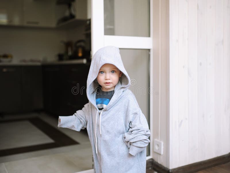 The Kid Poses in a Jacket of the Big Size Stock Image - Image of ...