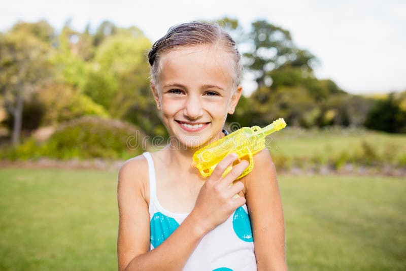 Kid Posing at Camera during a Sunny Day with Her Water Gun Stock Image ...