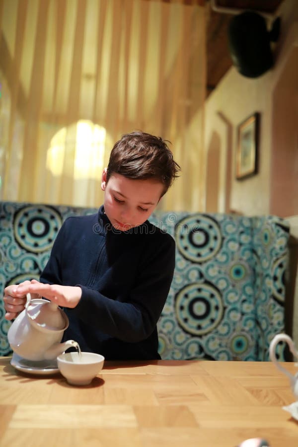 Kid Pouring Tea in Restaurant Stock Photo - Image of cute, indoor ...