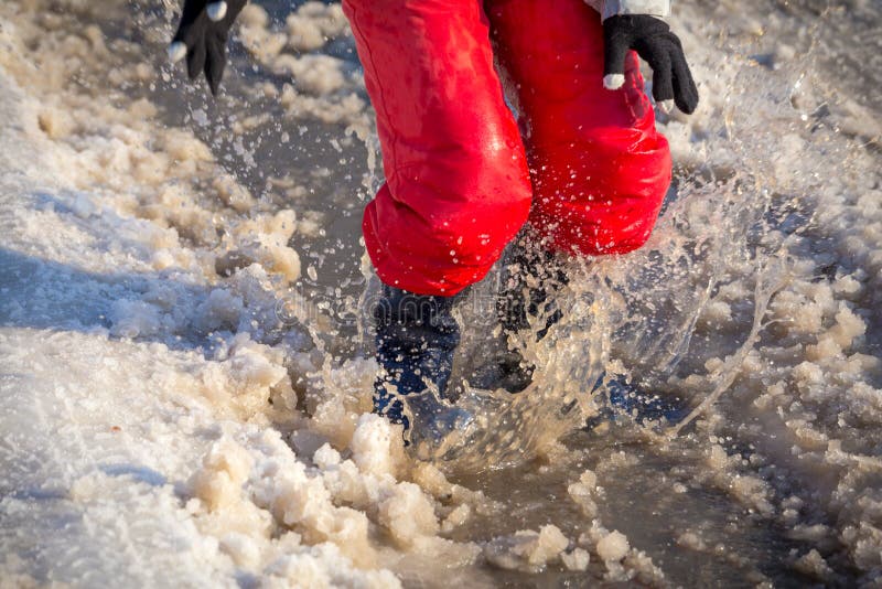 Kid in Rainboots Jumping in the Ice Puddle Stock Image - Image of ...