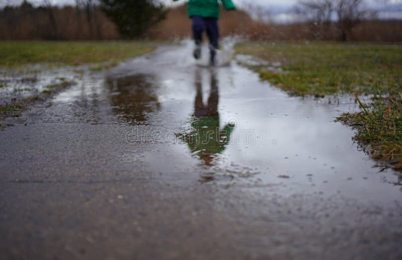 Kid reflection on sidewalk stock photo. Image of puddle - 207772490