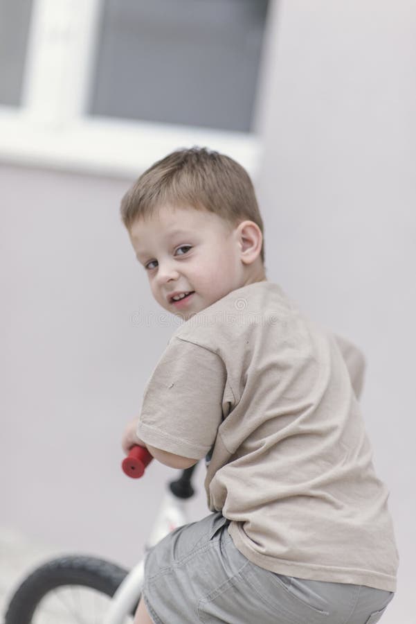 Kid riding a bicycle stock image. Image of playing, caucasian - 93112343