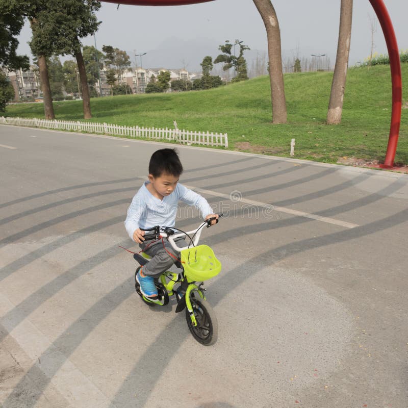 Kid riding stock image. Image of asian, childhood, bicycle - 68732363