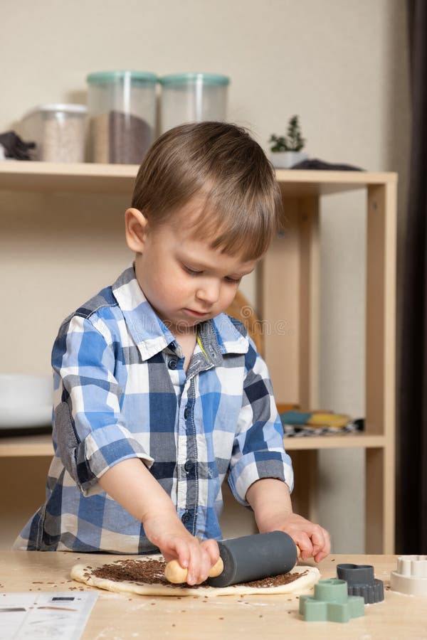 The Kid Rolls Out the Dough with a Rolling Pin, Makes His First Cookie ...