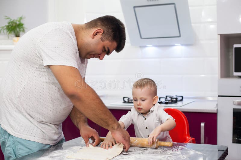 Kid Rolls Out the Pizza Dough. Happy Family in Kitchen Stock Image ... Kid Rolls Out the Pizza Dough. Happy Family in Kitchen Stock Image ...