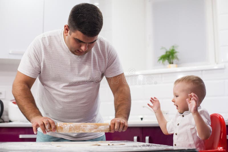 Kid Rolls Out the Pizza Dough. Happy Family in Kitchen Stock Photo ... Kid Rolls Out the Pizza Dough. Happy Family in Kitchen Stock Photo ...