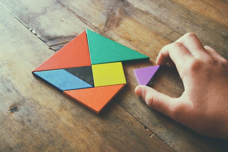Kid S Hand Holding a Missing Piece in a Square Tangram Puzzle, Over ...