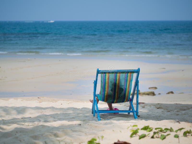 Kid sitting on beach chair stock image. Image of resort - 76351655