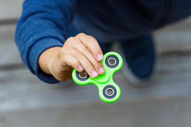 Kid Spinning a Fidget Spinner Device. Top View Stock Image - Image of ...