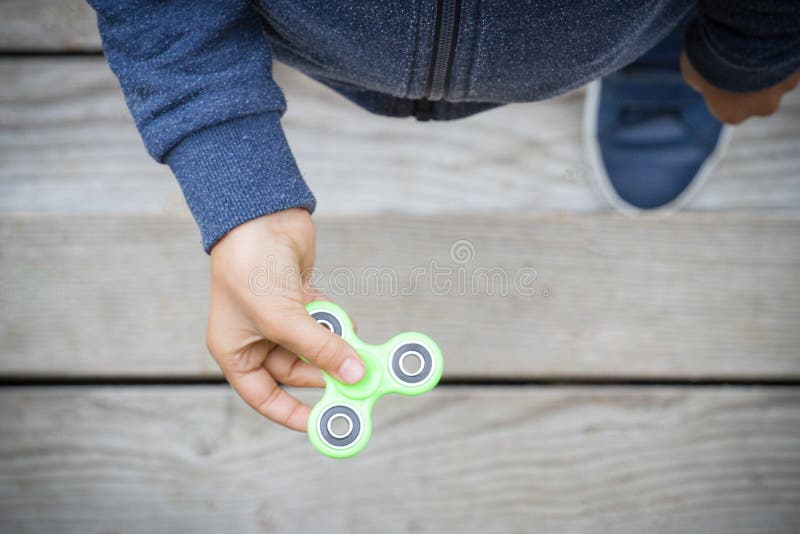 Kid Spinning a Fidget Spinner Device. Top View Stock Image - Image of ...