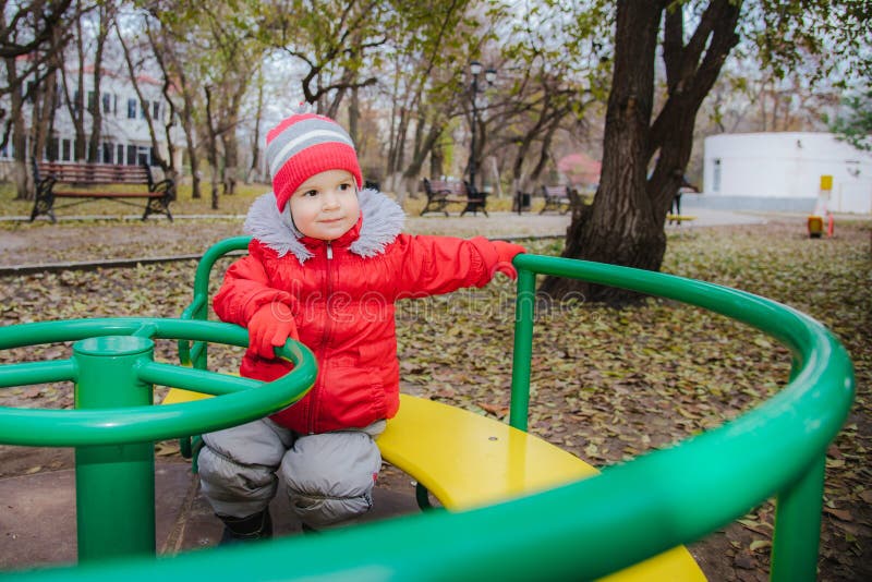 The Child is Spinning on a Swing in the Playground in the Park Stock ...