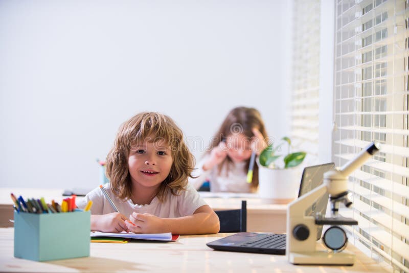 Kid Studying at School. Schoolchild Doing Homework at Classroom ...