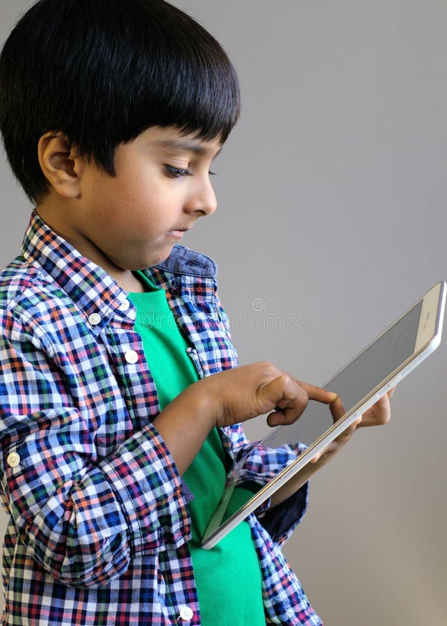 Kid Tapping on Tablet Computer. Child Using Tablet. Stock Photo - Image ...