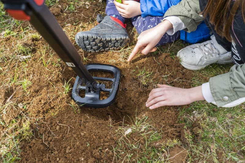 Kid Treasure Hunters Metal Detecting and Digging the Ground Stock Photo ...