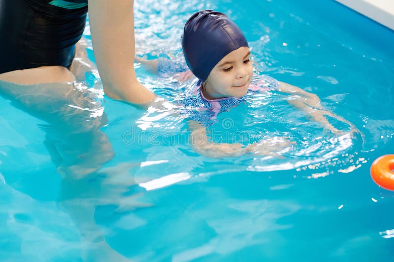 Kid try catch toy in pool stock image. Image of swim - 213811397
