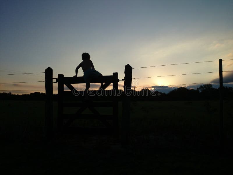 Kid under gate stock image. Image of playing, gate, horizon - 48387425