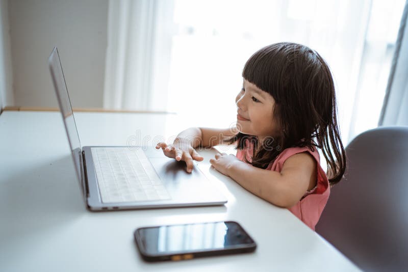 Kid using laptop at home stock image. Image of people - 183727827