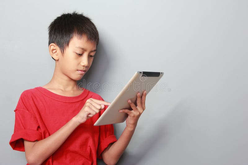 Boy plays tablet stock photo. Image of daytime, childhood - 44412330