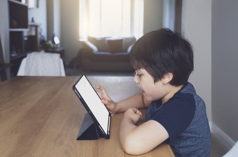 Kid Using Tablet Studying Homework, Child Using Digital Tablet for His ...